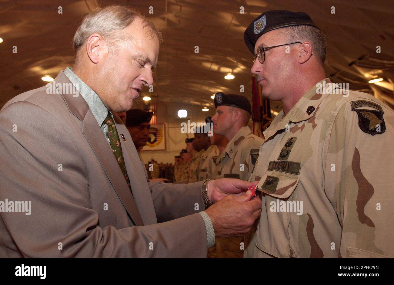 Secretary of the Army Thomas E. White, left, pins a bronze star medal ...