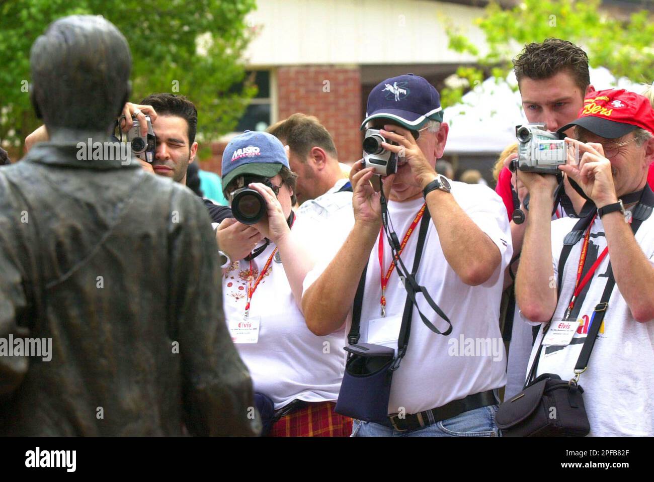Fans flock to take pictures of a statue depicting Elvis Presley at age ...