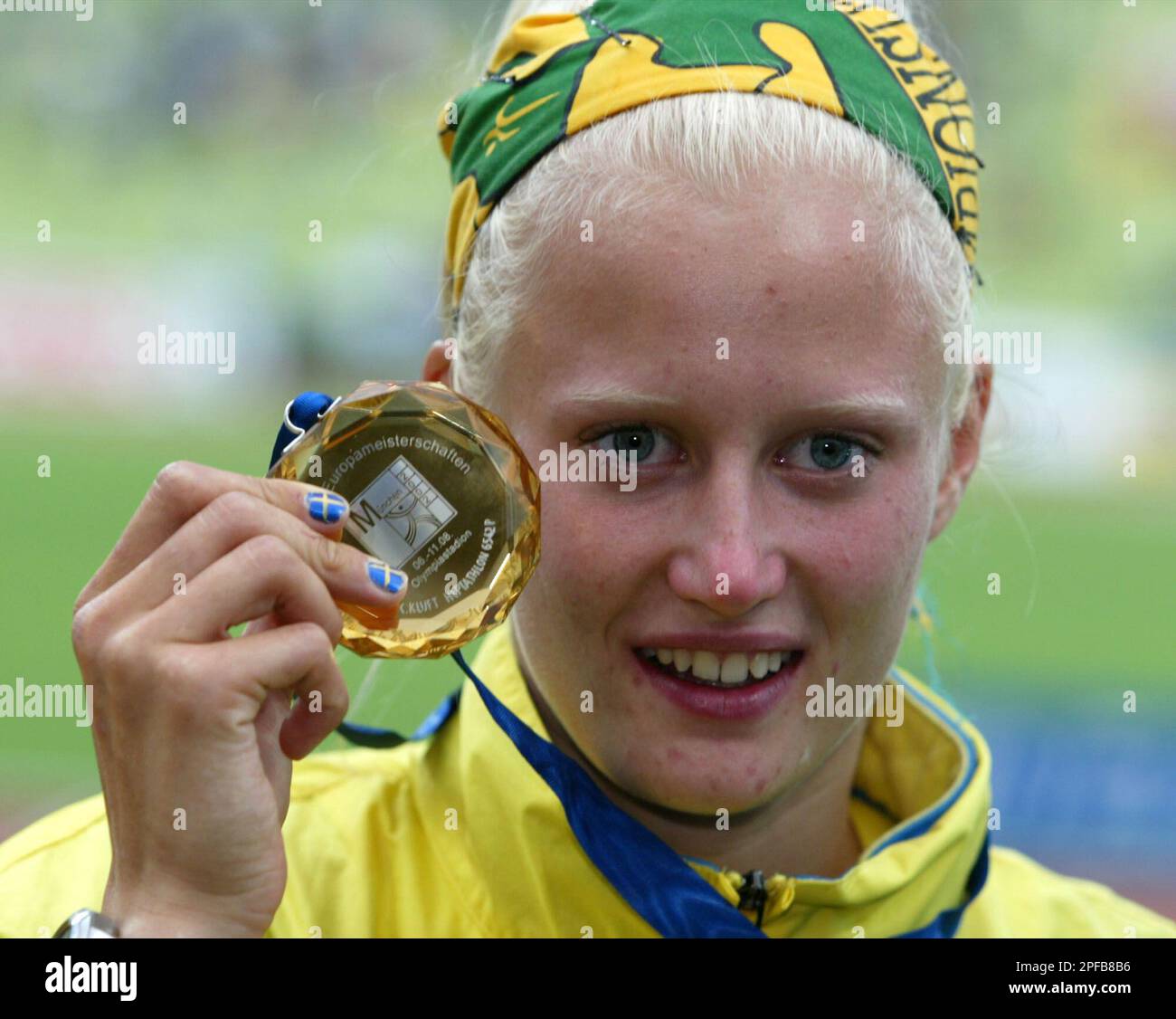 Sweden's Carolina Kluft displays the gold medal she won in the ...