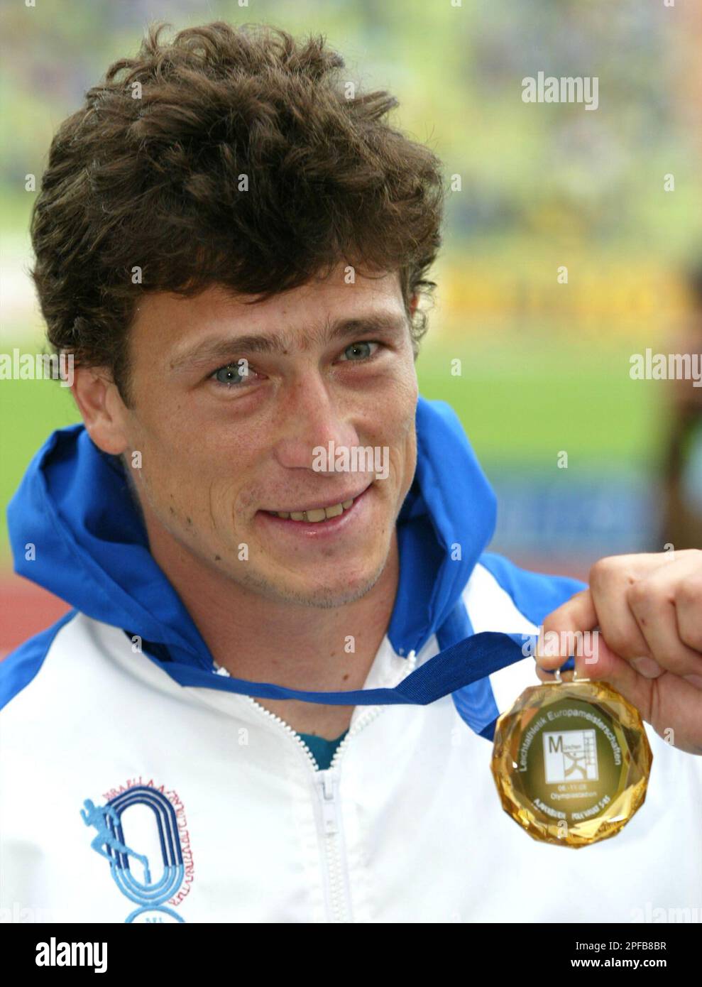 Israel's Alex Averbukh displays the gold medal he won in the pole vault ...
