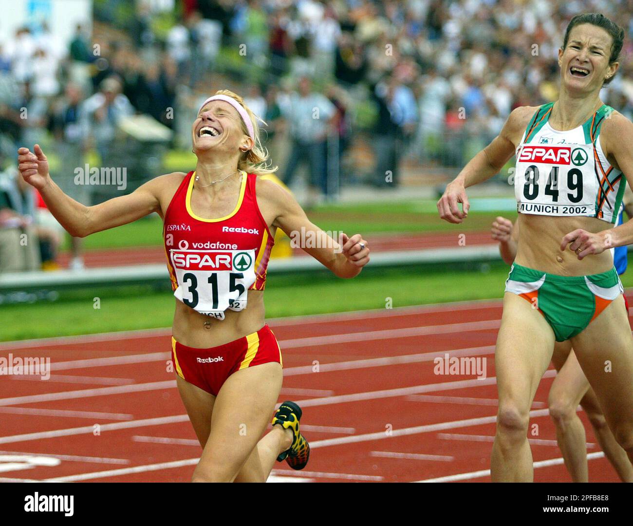 Spain's Marta Dominguez, left, celebrates as she crosses the finish ...