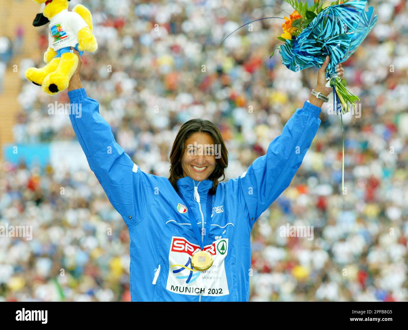 Italy's Maria Guida, gold, waves as she stands on the podium during the ...