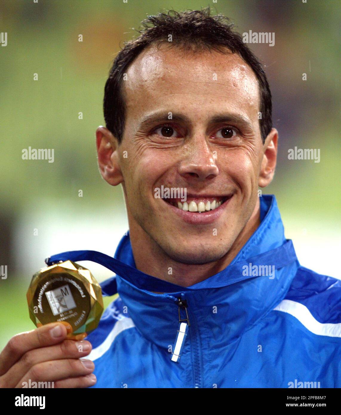 Greece's Konstantinos Kenteris displays the gold medal he won in the ...