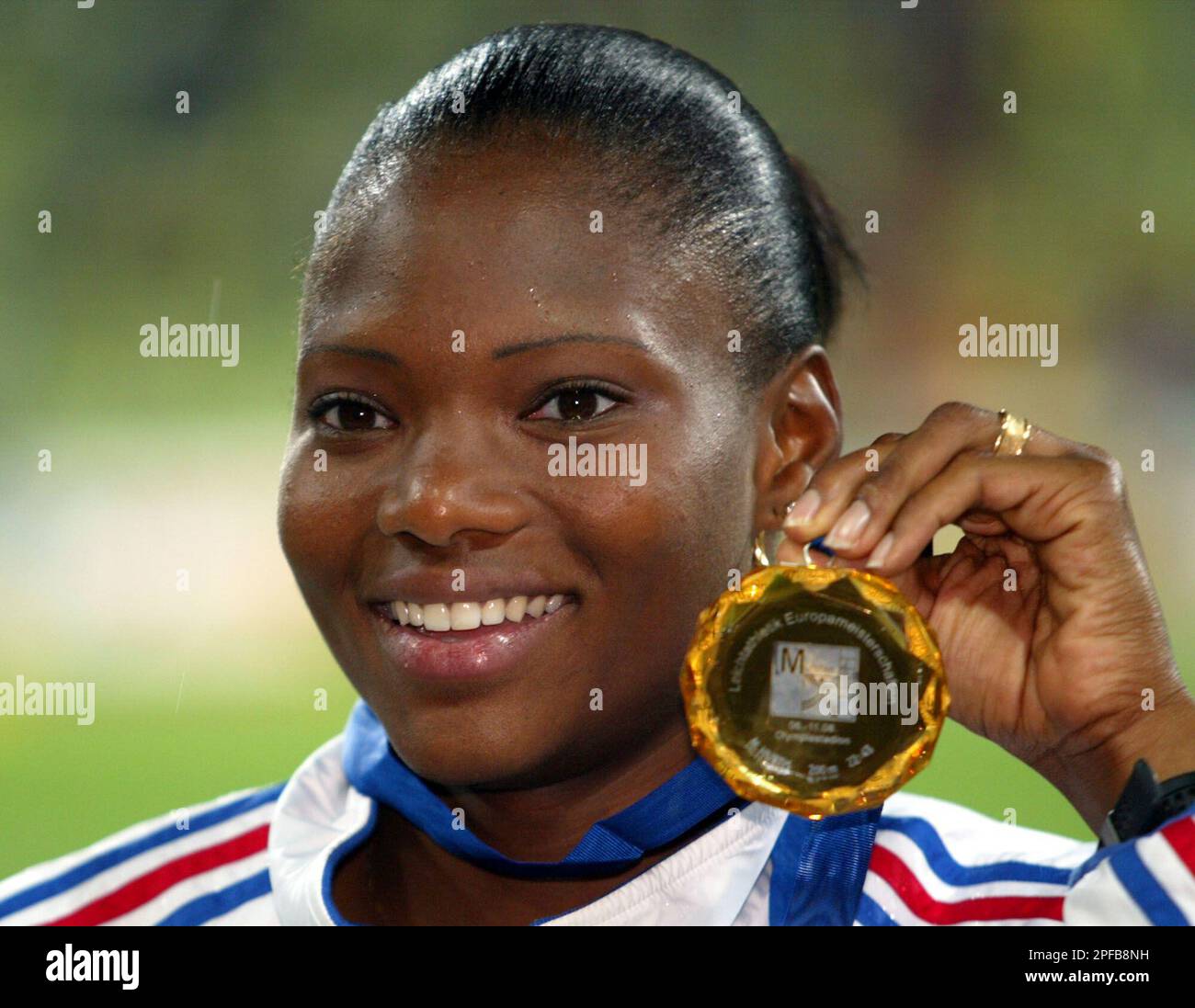 France's Muriel Hurtis displays the gold medal she won in the women's ...