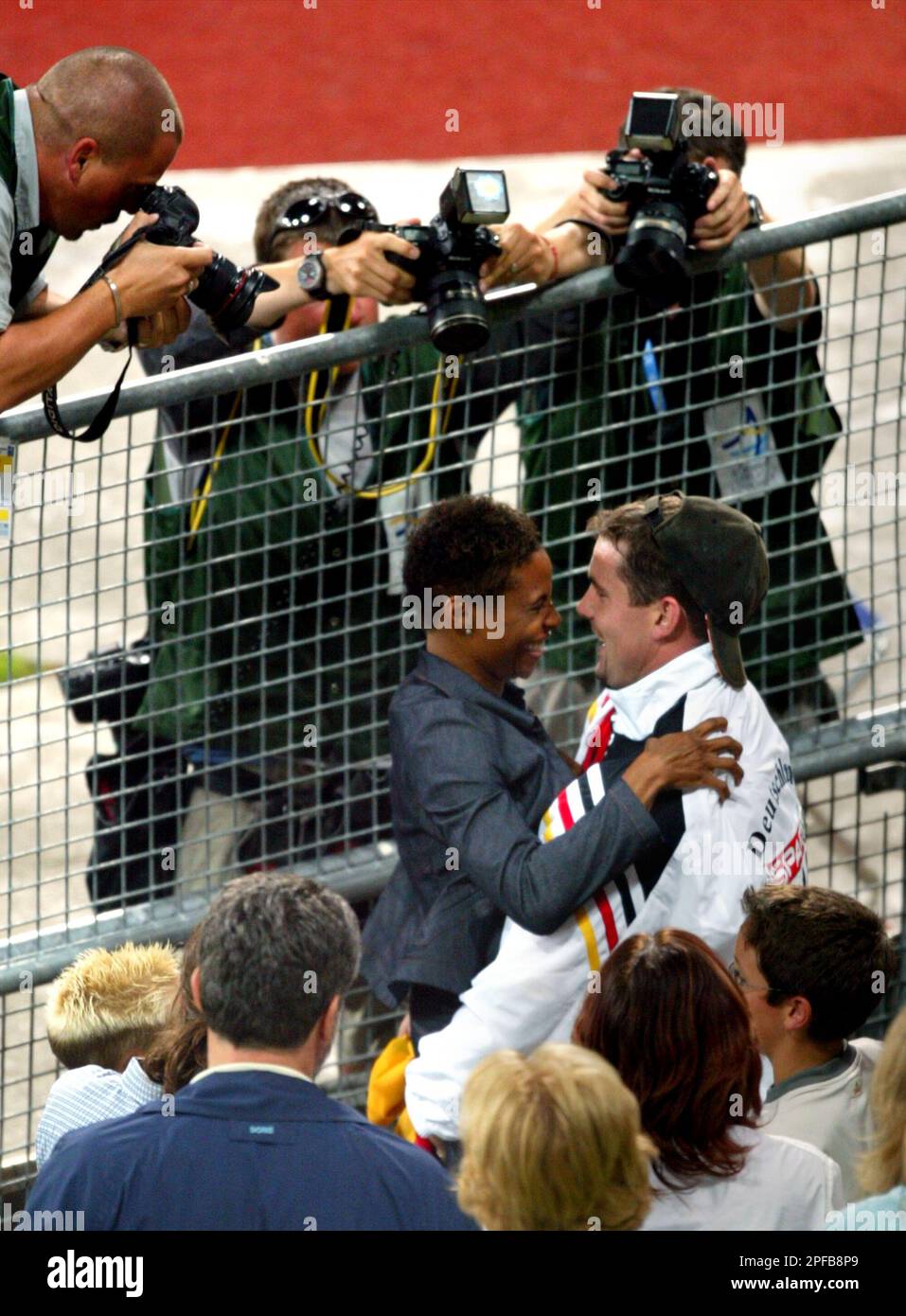 Bronze medal winner Boris Henry of Germany, right, hugs an unidentified ...
