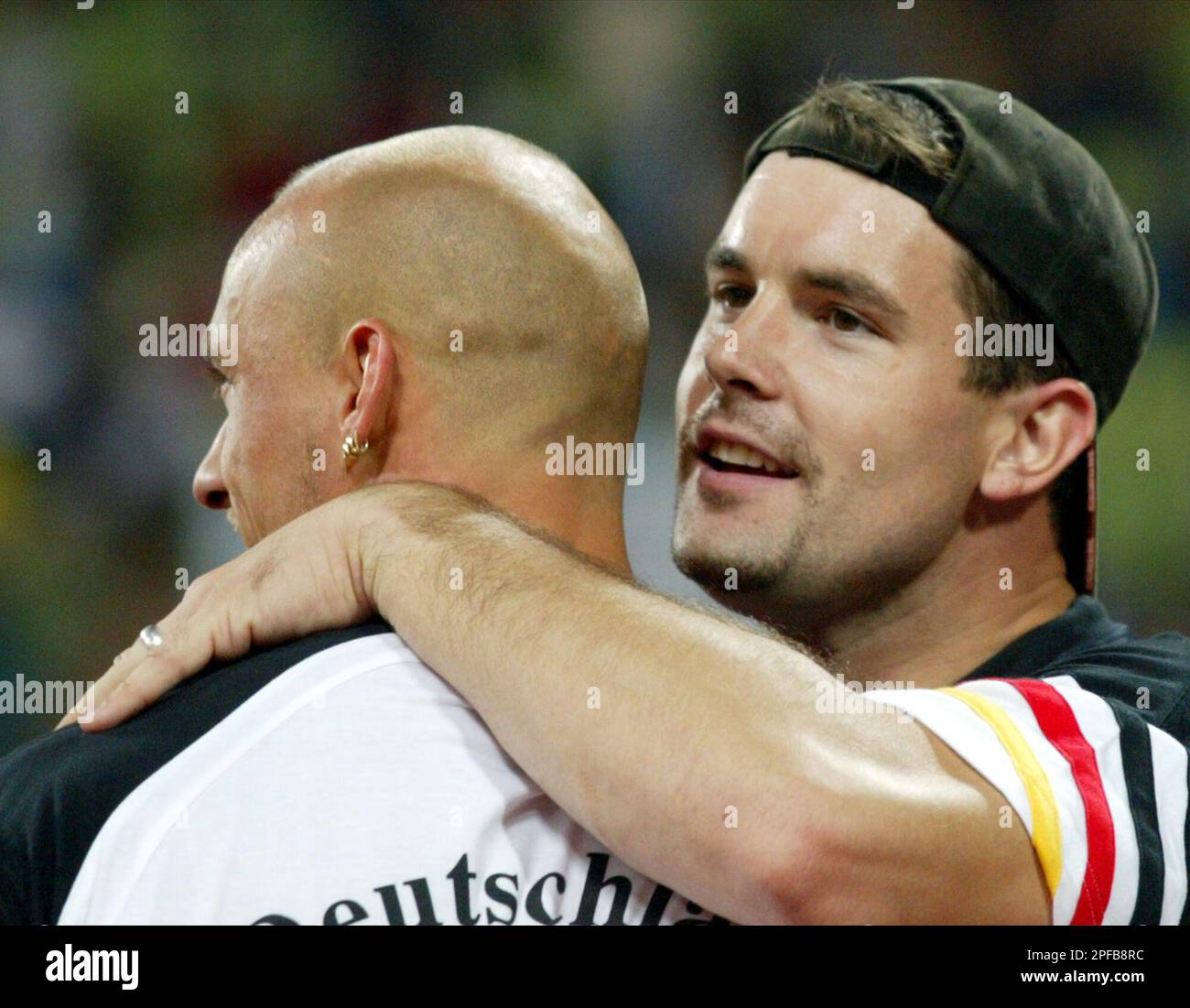 Bronze medal winner Boris Henry of Germany, right, hugs team mate ...