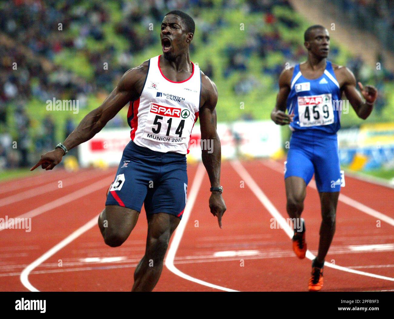British Dwain Chambers, left, crosses the finish line to win the men's ...