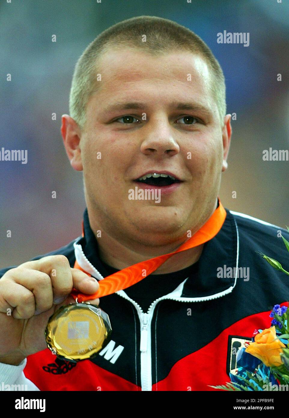 Germany's Ralf Bartels shows the bronze medal he won in the Men's shot ...