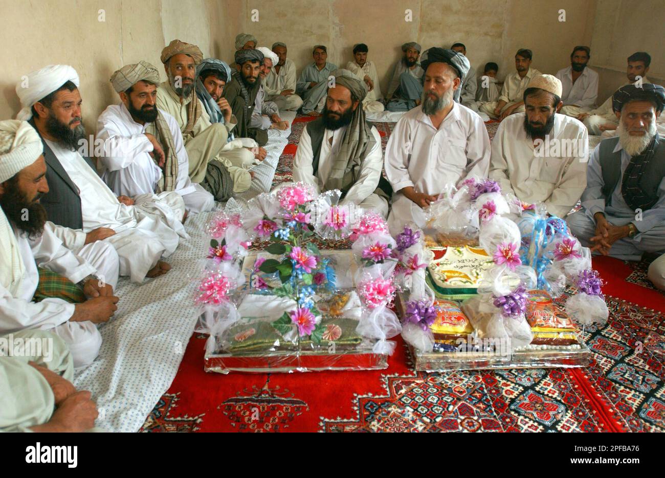Family members, religious leaders, and guests gather for a "Nikah ...