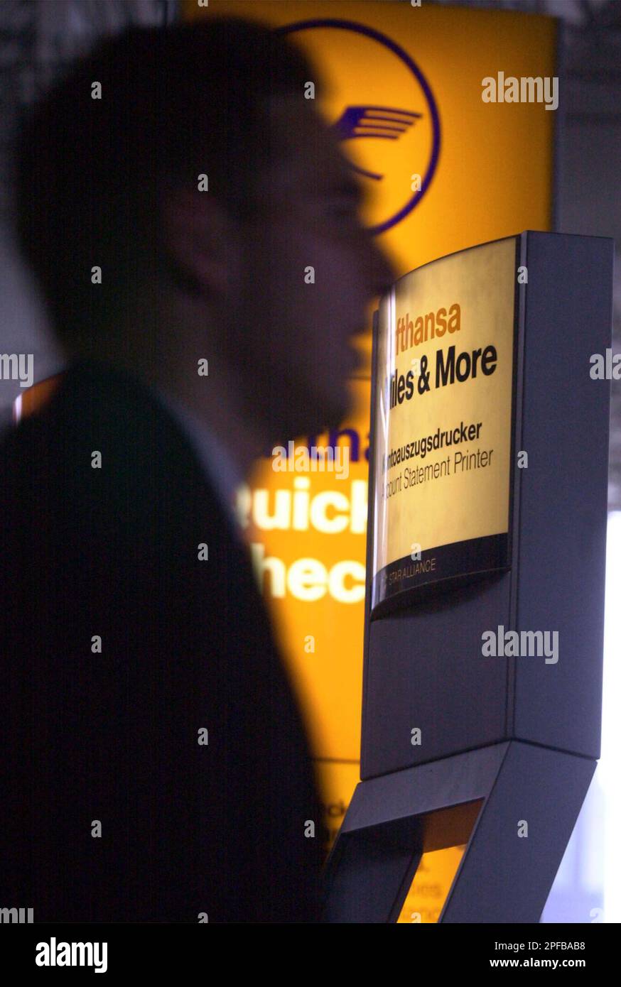 An unidentified passenger passes Lufthansa Quick Check-In counters and ...