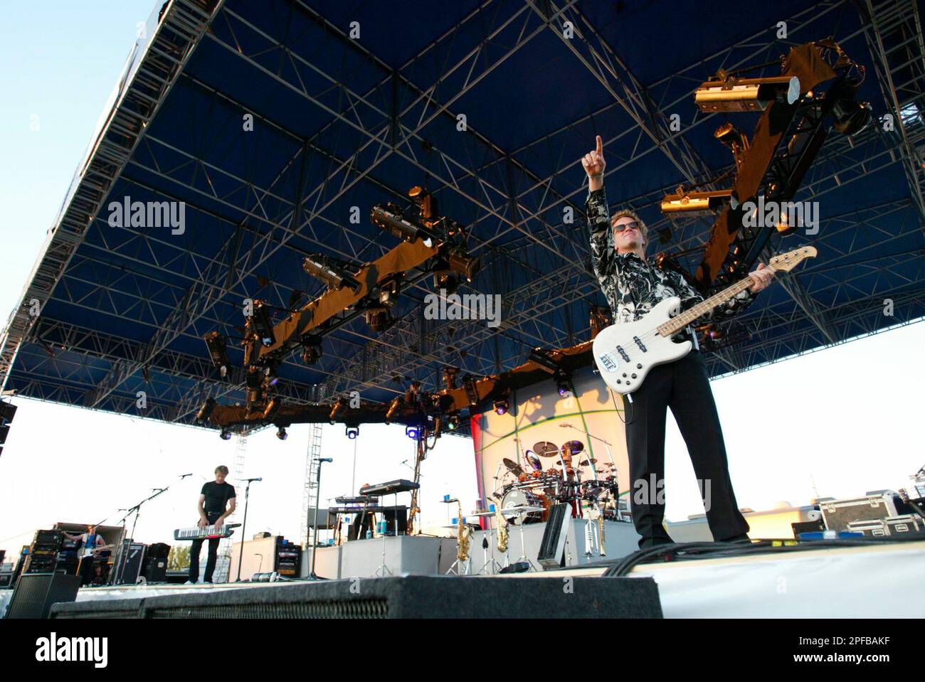 Guitarist Jason Scheff from the band Chicago points to the crowd ...