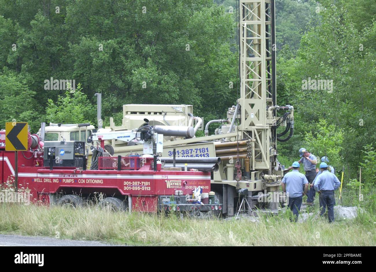 Volunteer crew from Wayne's Wells in Salibury, Pa., drill holes down ...
