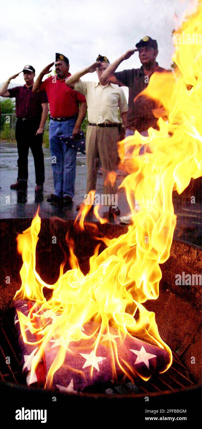 Members of the American Legion Post in Columbus, Ind., salute as "To ...