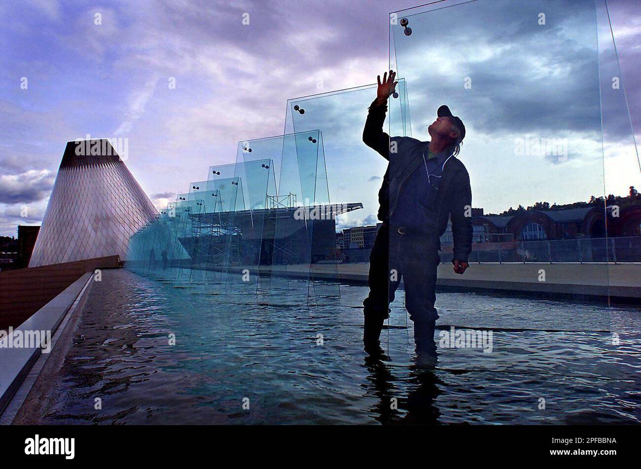 Artist Buster Simpson checks the positioning of glass panels that ...
