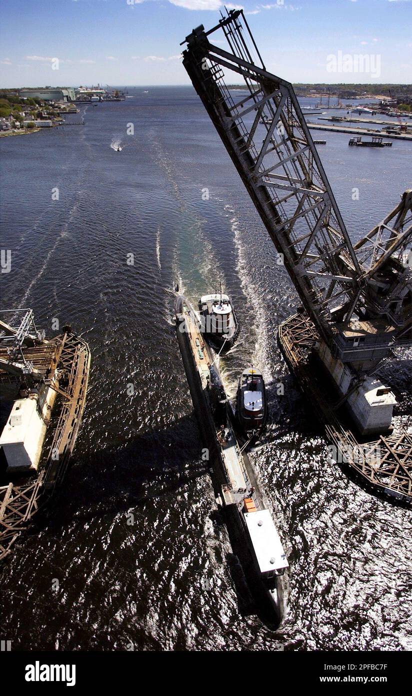 The historic nuclear submarine USS Nautilus passes under the Thames ...