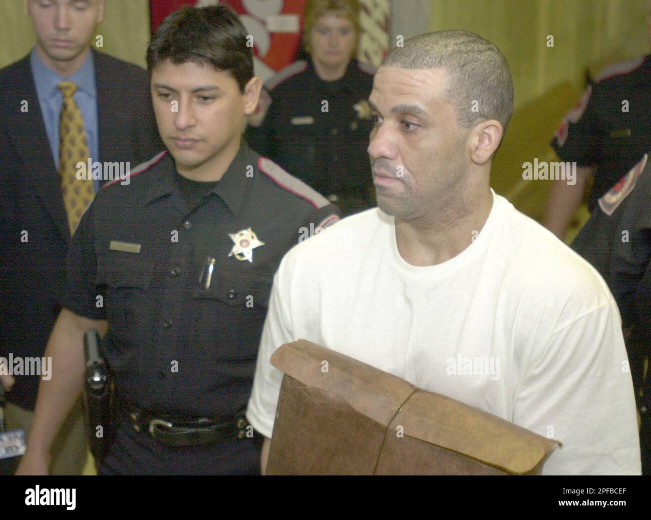 Napoleon Beazley, at right, is escorted by an unidentified court ...