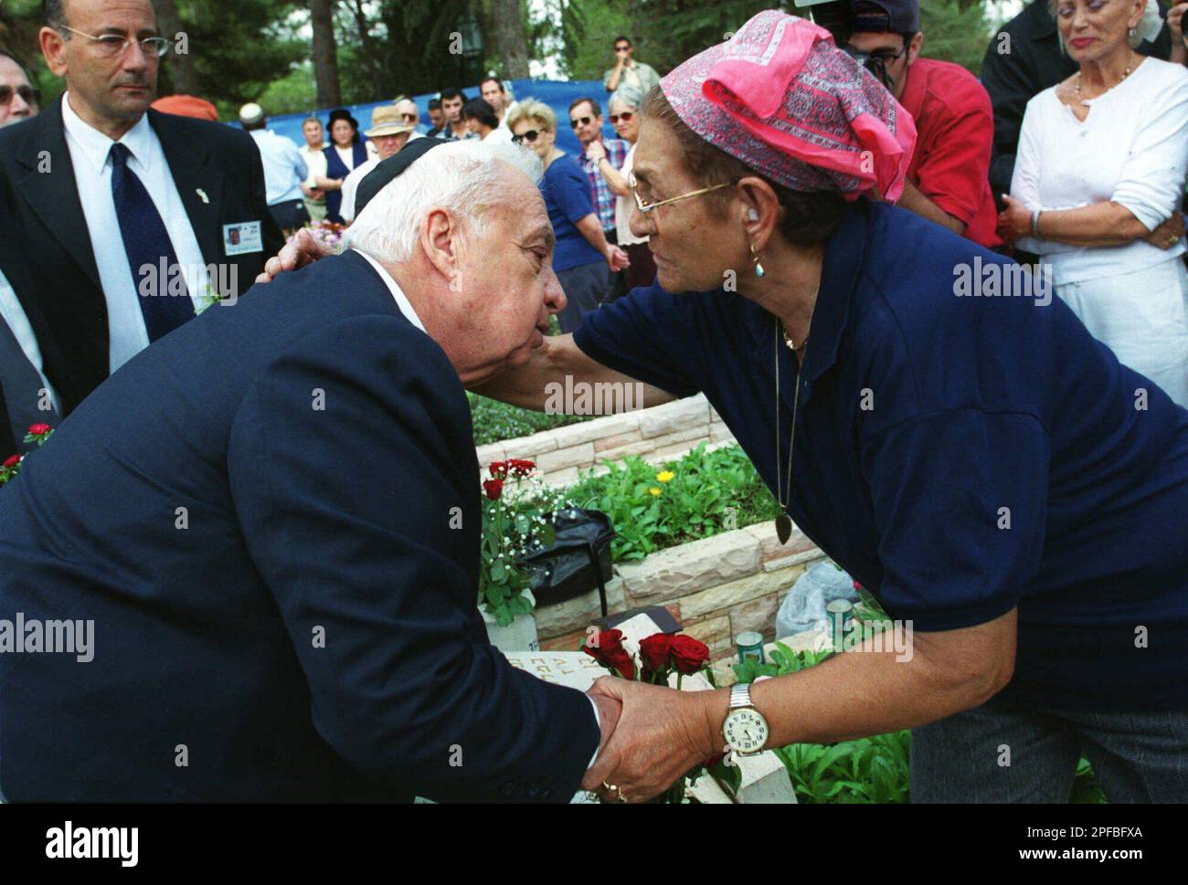 Israeli Prime Minister Ariel Sharon, left, leans to kiss an ...