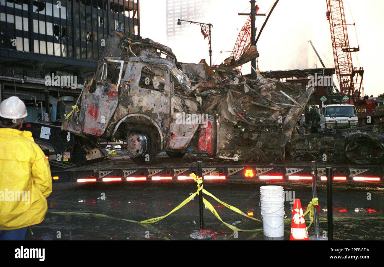 A rescue worker watches as the remains of a fire truck that was ...