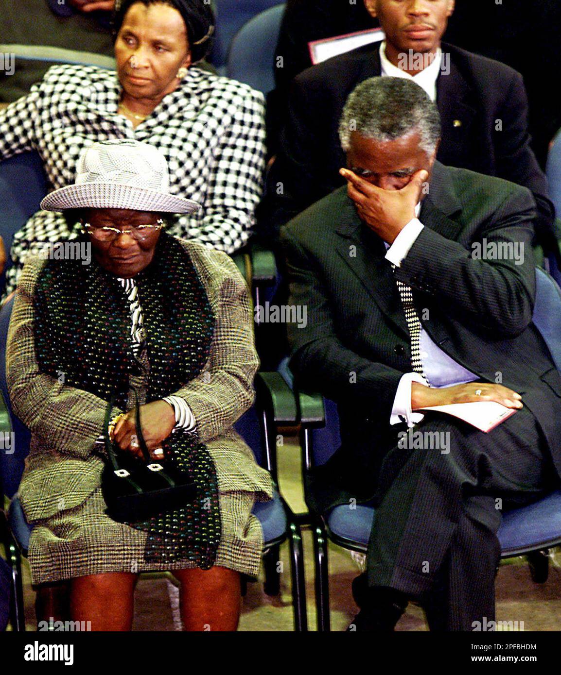 South African president Thabo Mbeki, right, wipes his eyes during the ...