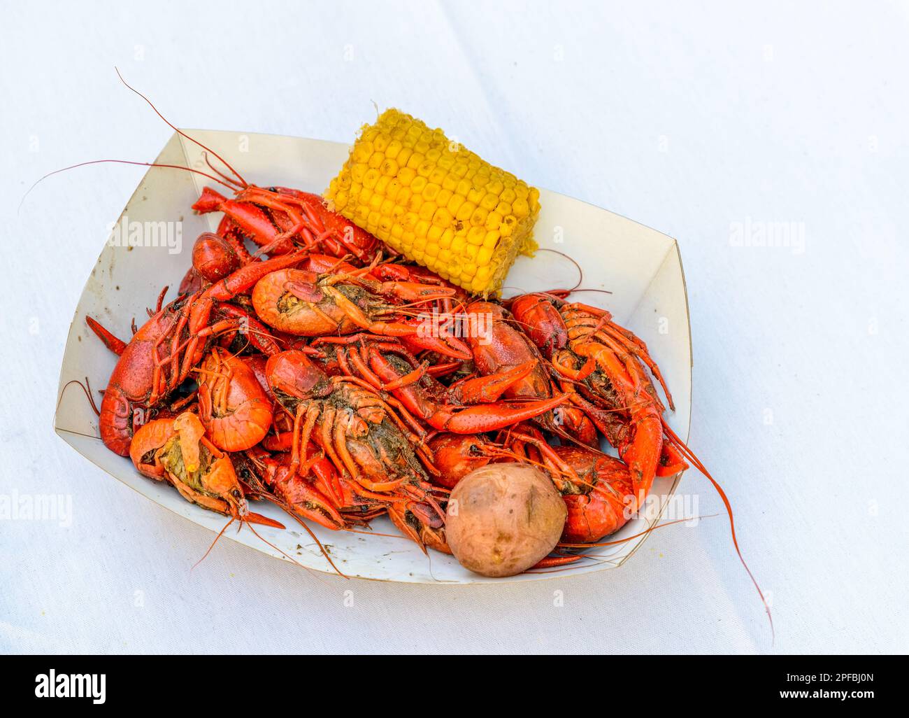 Small serving of boiled crawfish, a side of corn and a potato Stock ...
