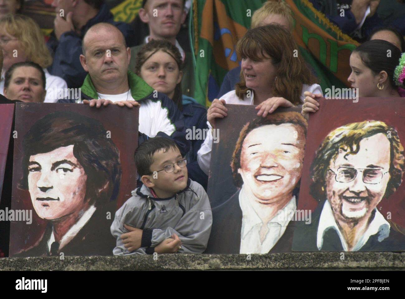 A young Catholic boy stands between pictures memorializing hunger ...