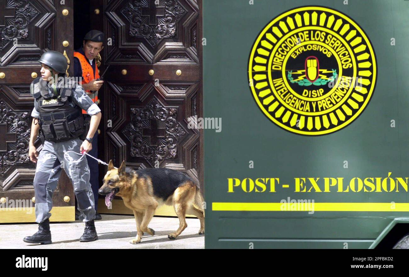 A bomb expert with the secret police and a police dog leave the San ...