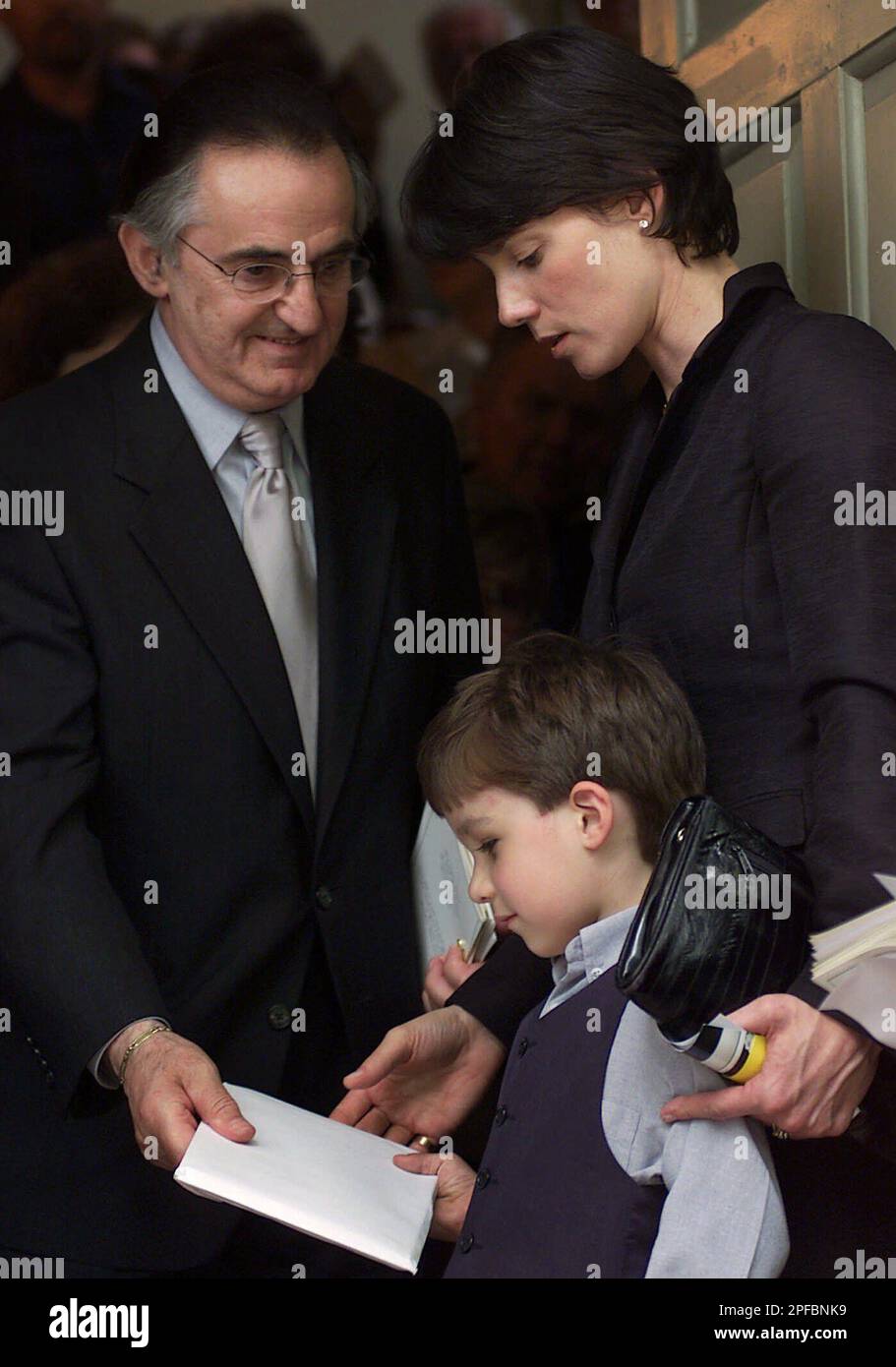 Katherine Quinn looks at her son Ryan Quinn as an unidentifed man hands ...