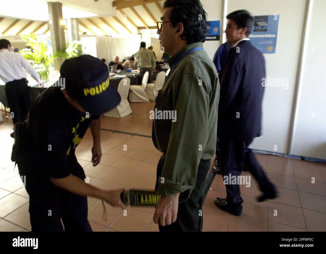 Costa Rican police inspect a journalist at a security checkpoint at the ...