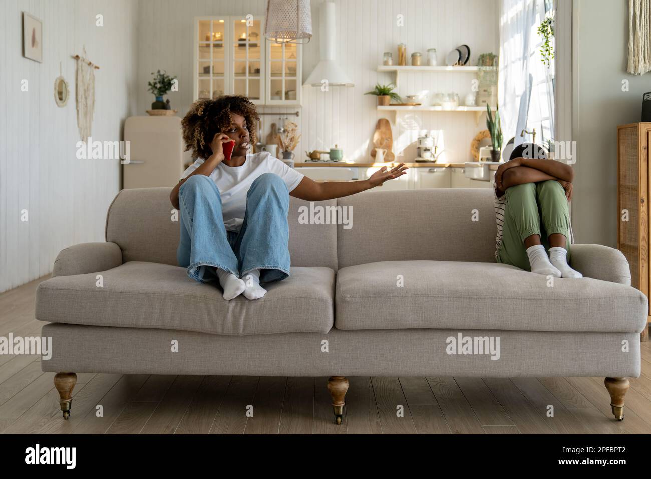 Annoyed unhappy African American mother talking on phone complaining ... Annoyed unhappy African American mother talking on phone complaining ...