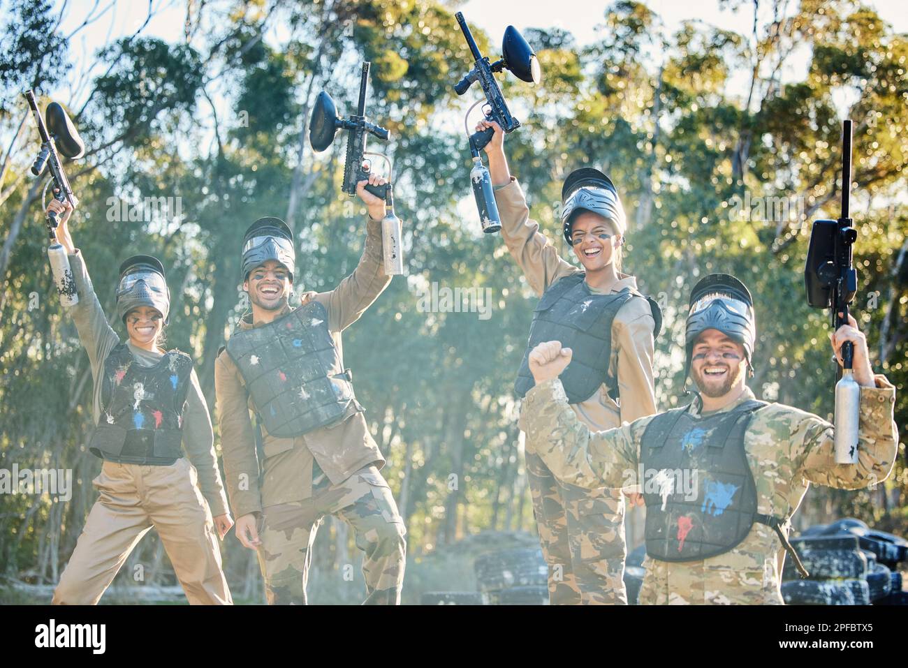 Team, paintball and portrait in celebration for winning, victory or ...