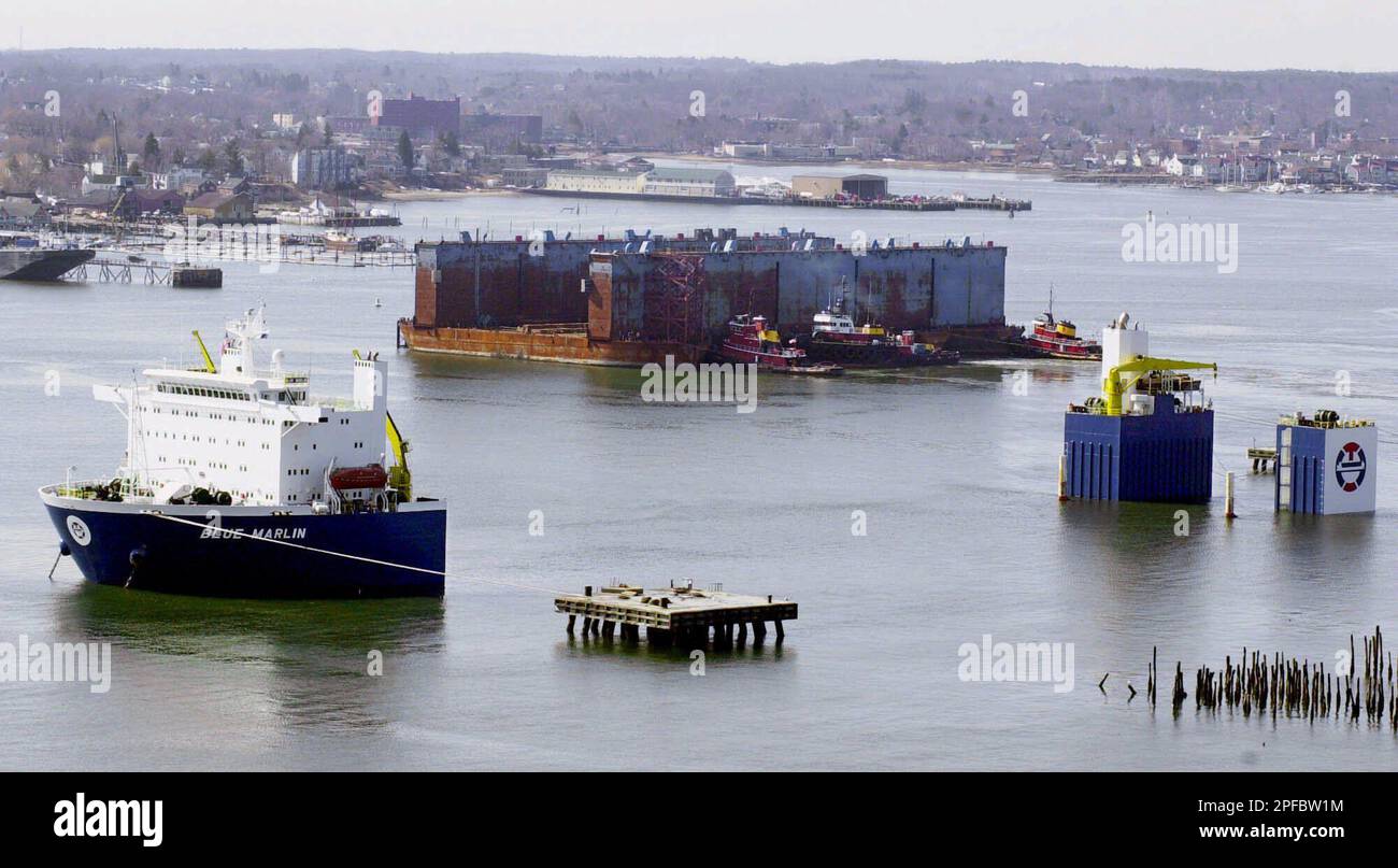 The first half of the Bath Iron Works dry dock is pushed by tug boats ...