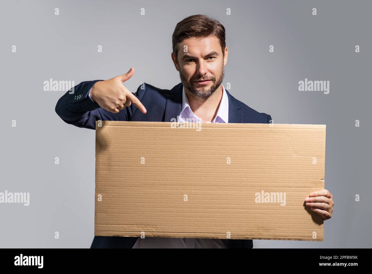 Business man holds sign, blank card. Placard ready for your product ...
