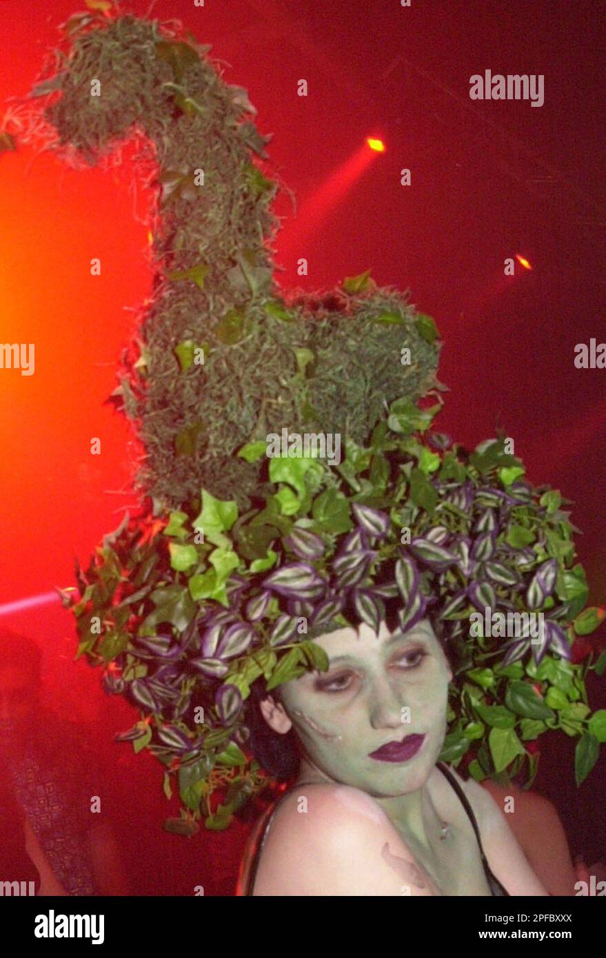 Anastasia Heonis wears a topiary-type sculpture on her head during the ...