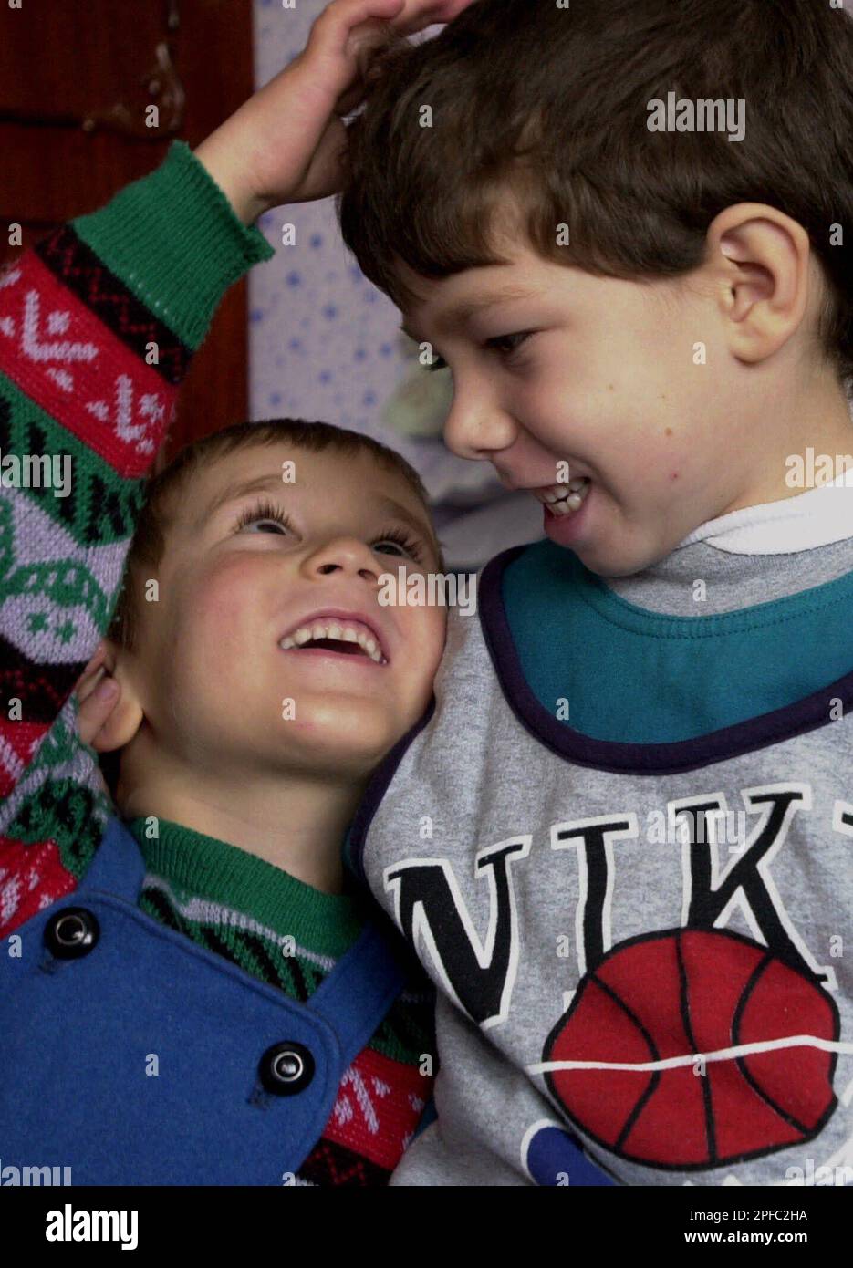 Madalin, a 5-year-old Romanian orphan, plays with his 6-year-old foster ...