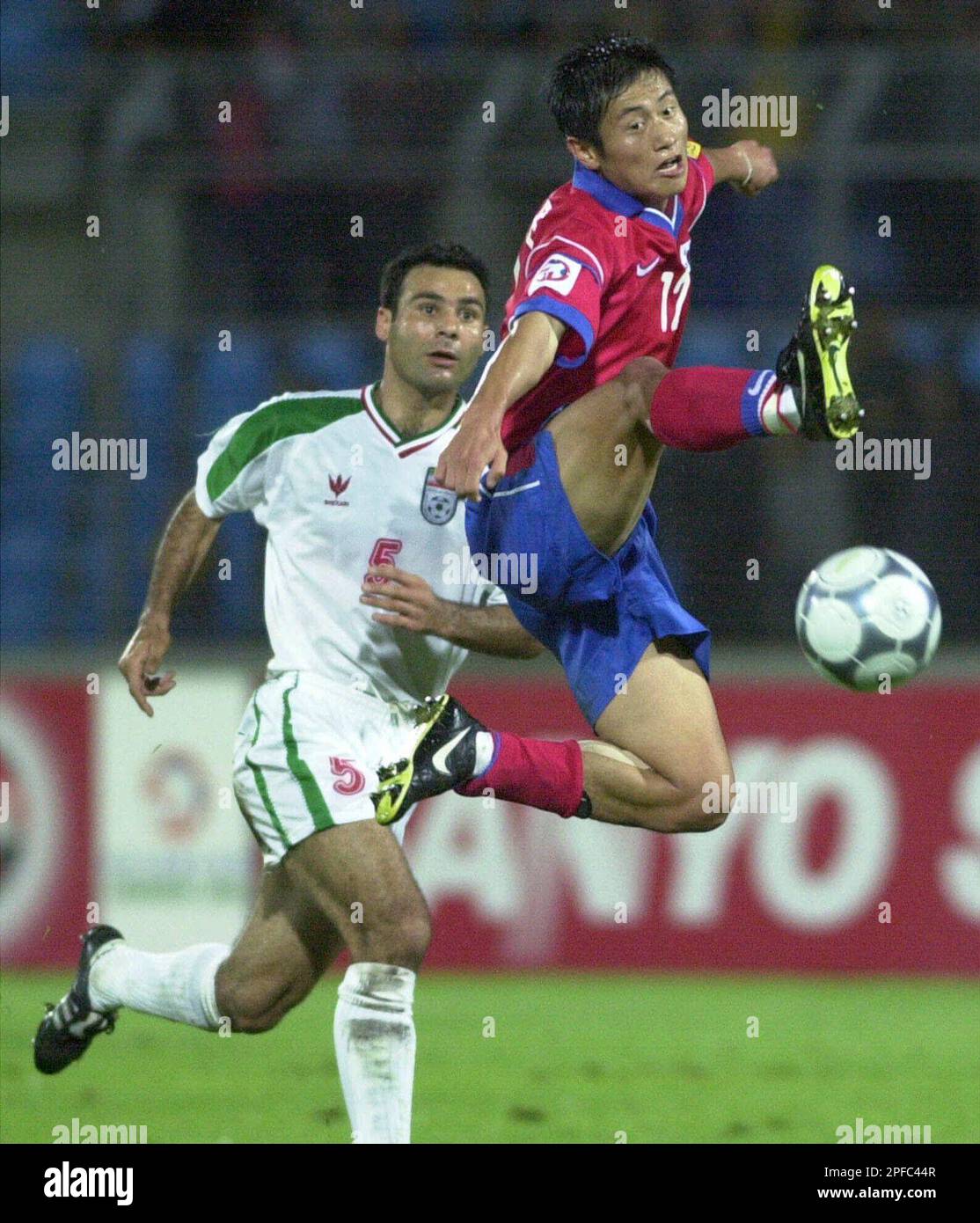 Lee Young-Pyo of South Korea kicks the ball in front of Sohrab ...