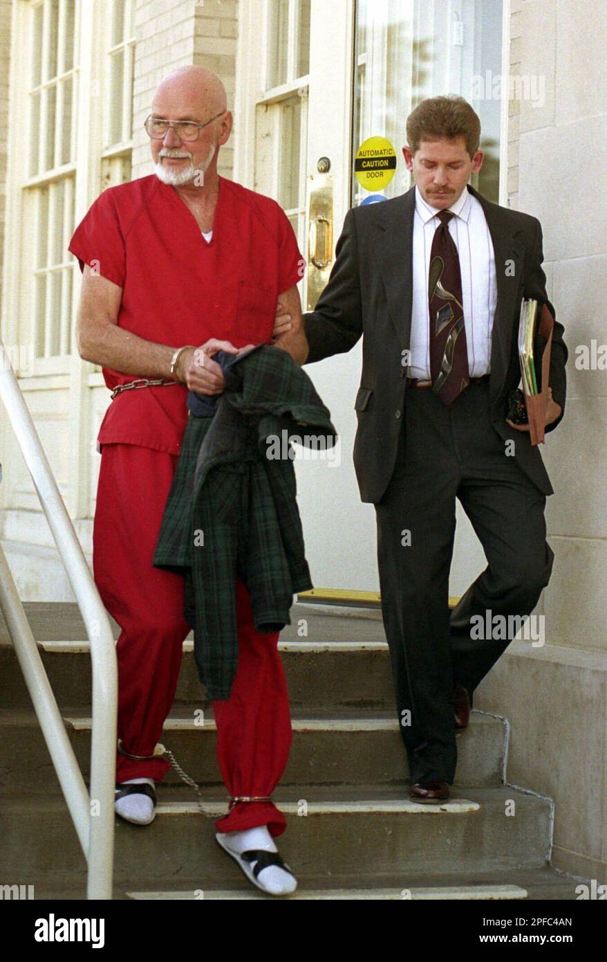 A handcuffed and shackled Robert Spangler, left, is escorted from the U ...