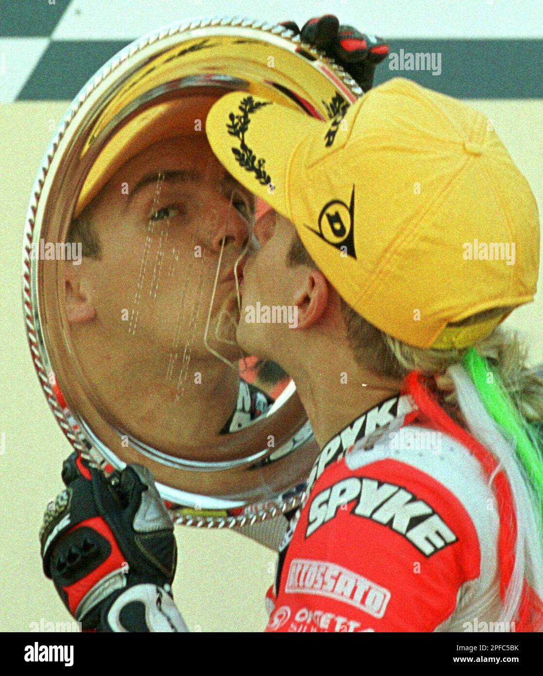 Roberto Locatelli of Italy kisses the trophy after winining the 125cc ...