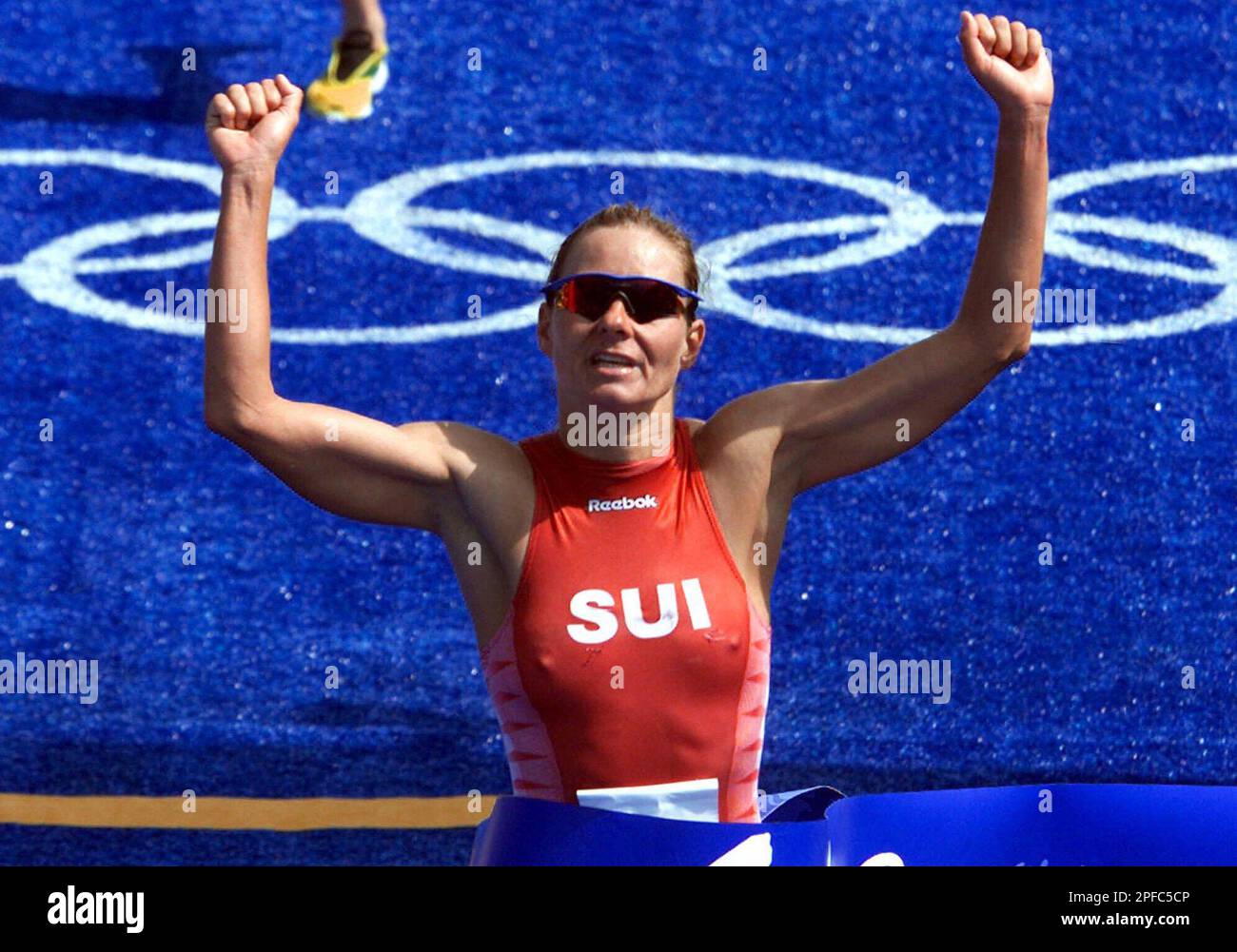 Switzerland's Brigitte MacMahon celebrates as she crosses the finish ...