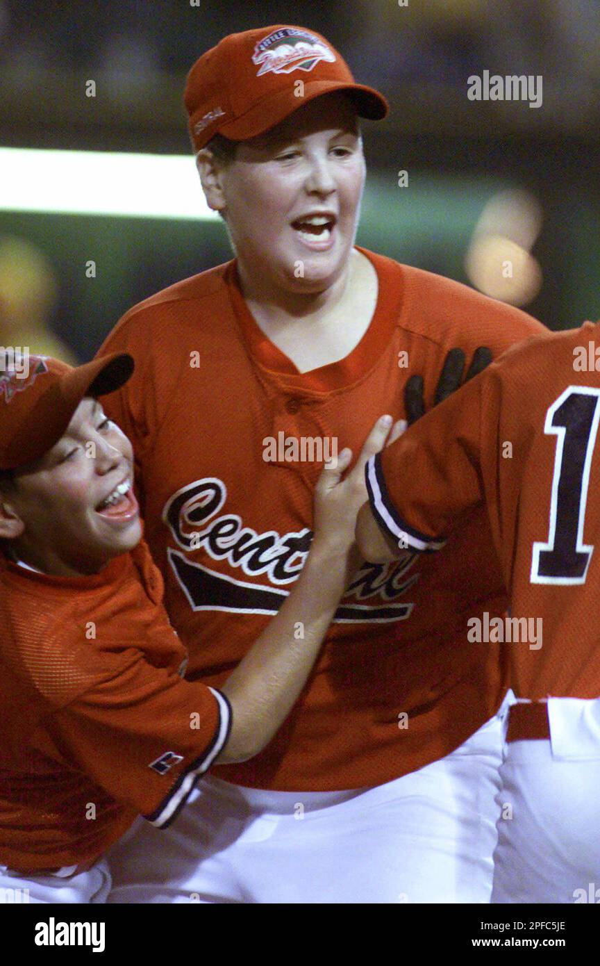 Davenport, Iowa winning pitcher Dan O'Donnell, center, is hugged by ...