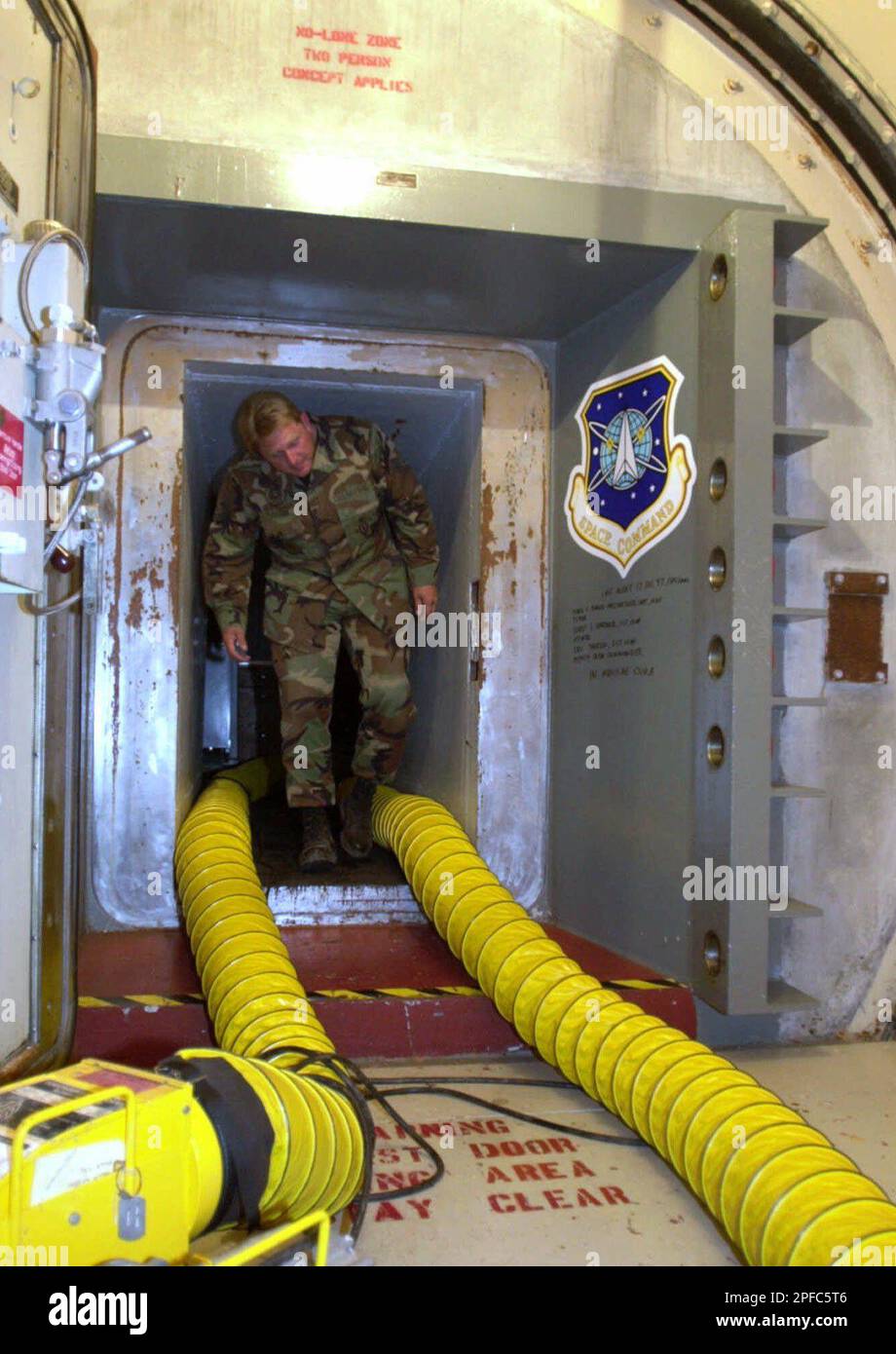 Air Force Sgt. Steve Marback stoops July 20, 2000 to pass through the ...