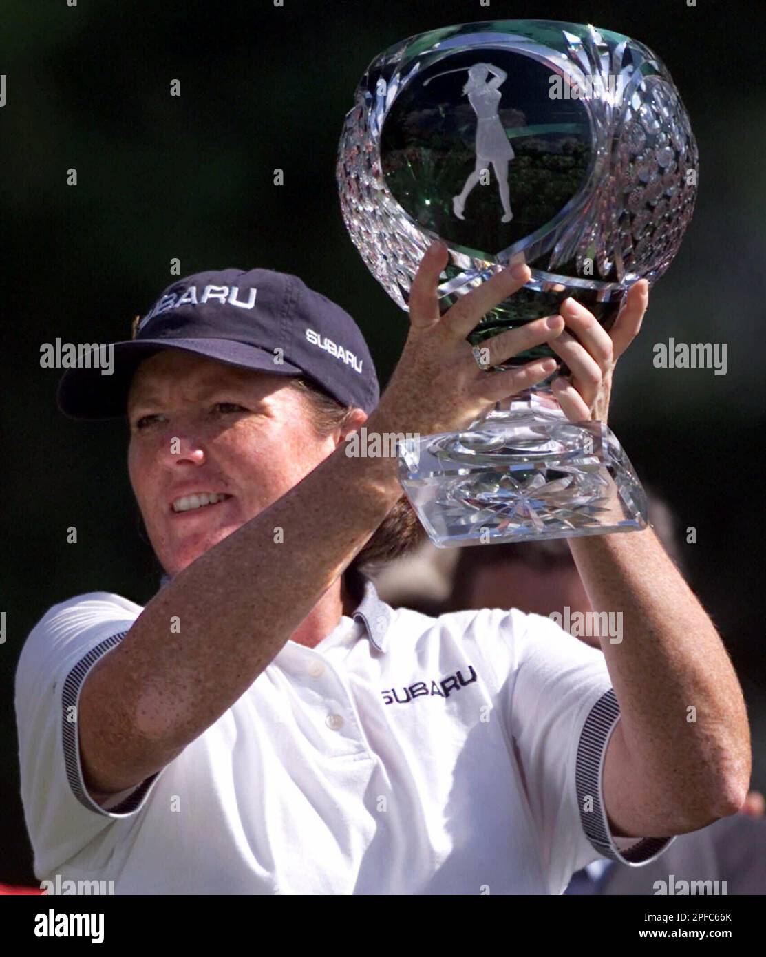 Meg Mallon from Natick, Mass., holds up the trophy following her win at ...