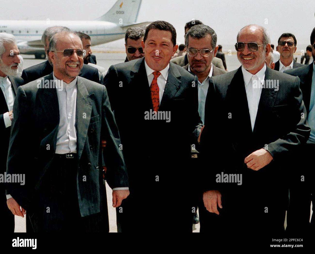 Venezuelan President Hugo Chavez, center, is accompained by Iranian Oil ...