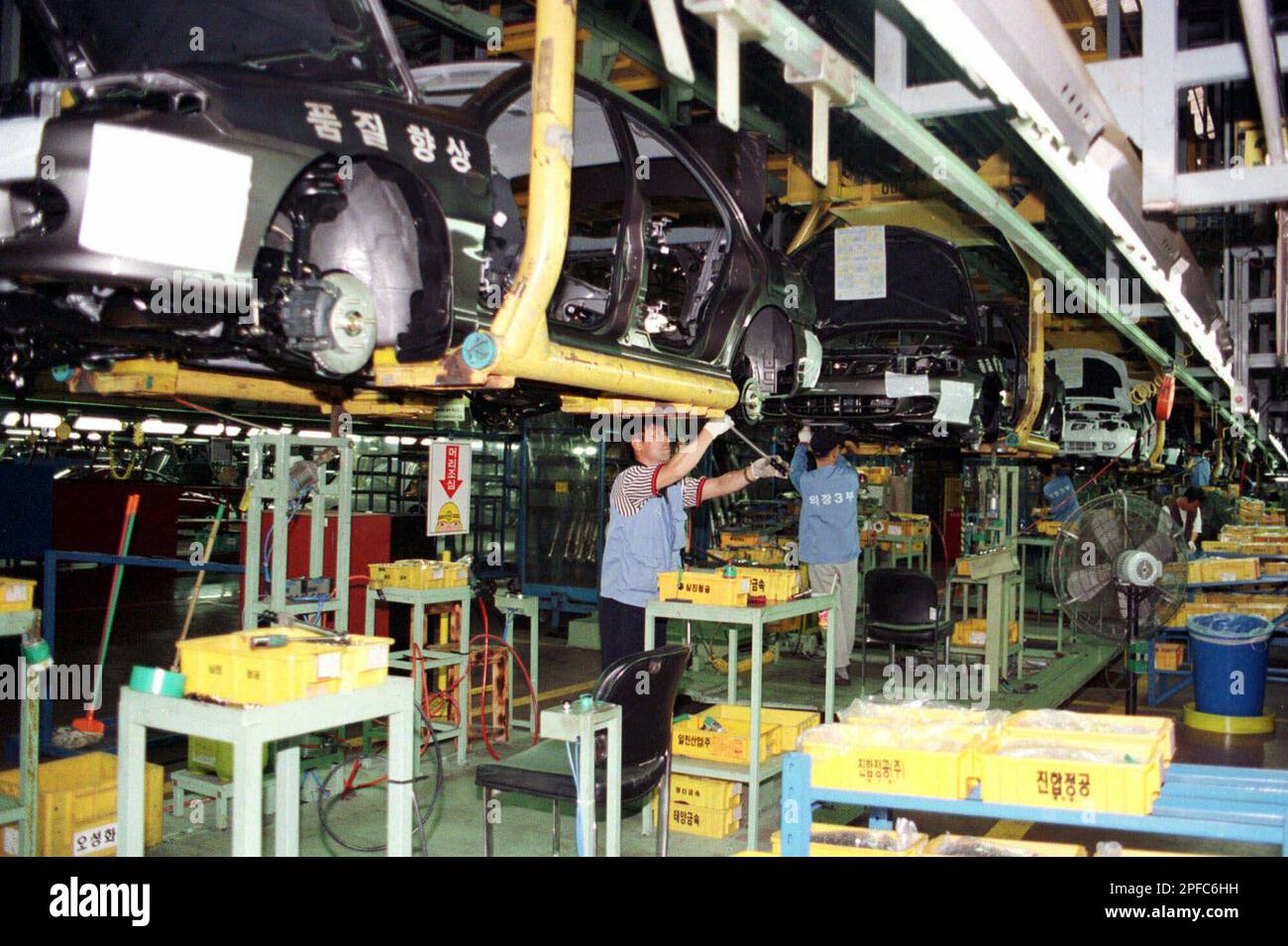 South Korea's Hyundai Motors Co. workers work at the assembly line of ...