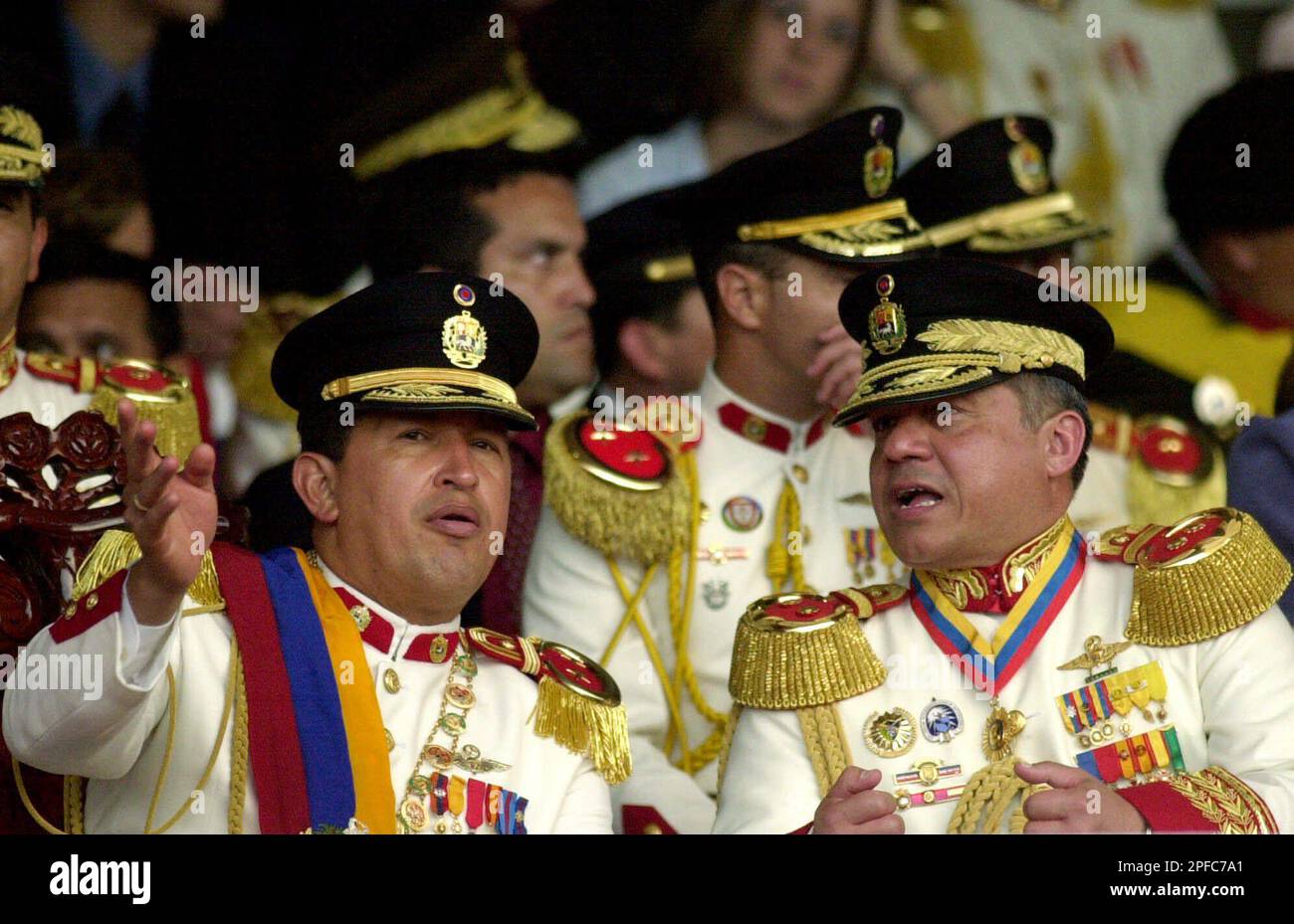 Venezuelan President Hugo Chavez, left, wearing a full military uniform ...