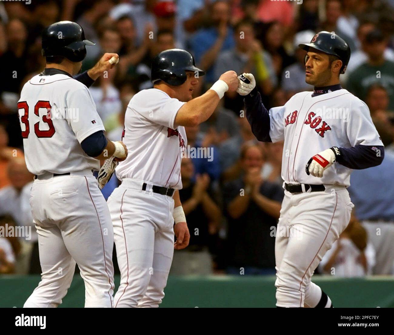 Boston Red Sox's Brian Daubach, right, taps knuckles with teammates ...