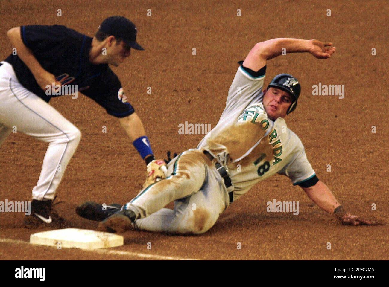 Florida Marlins' Mark Smith (18) is tagged out by New York Mets third ...