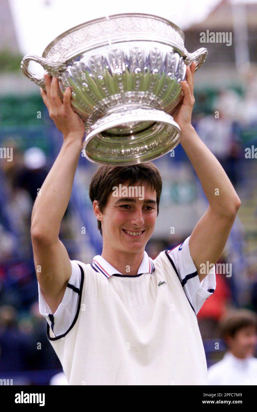 Julie Halard-Decugis of France lifts the trophy after beating Dominique ...