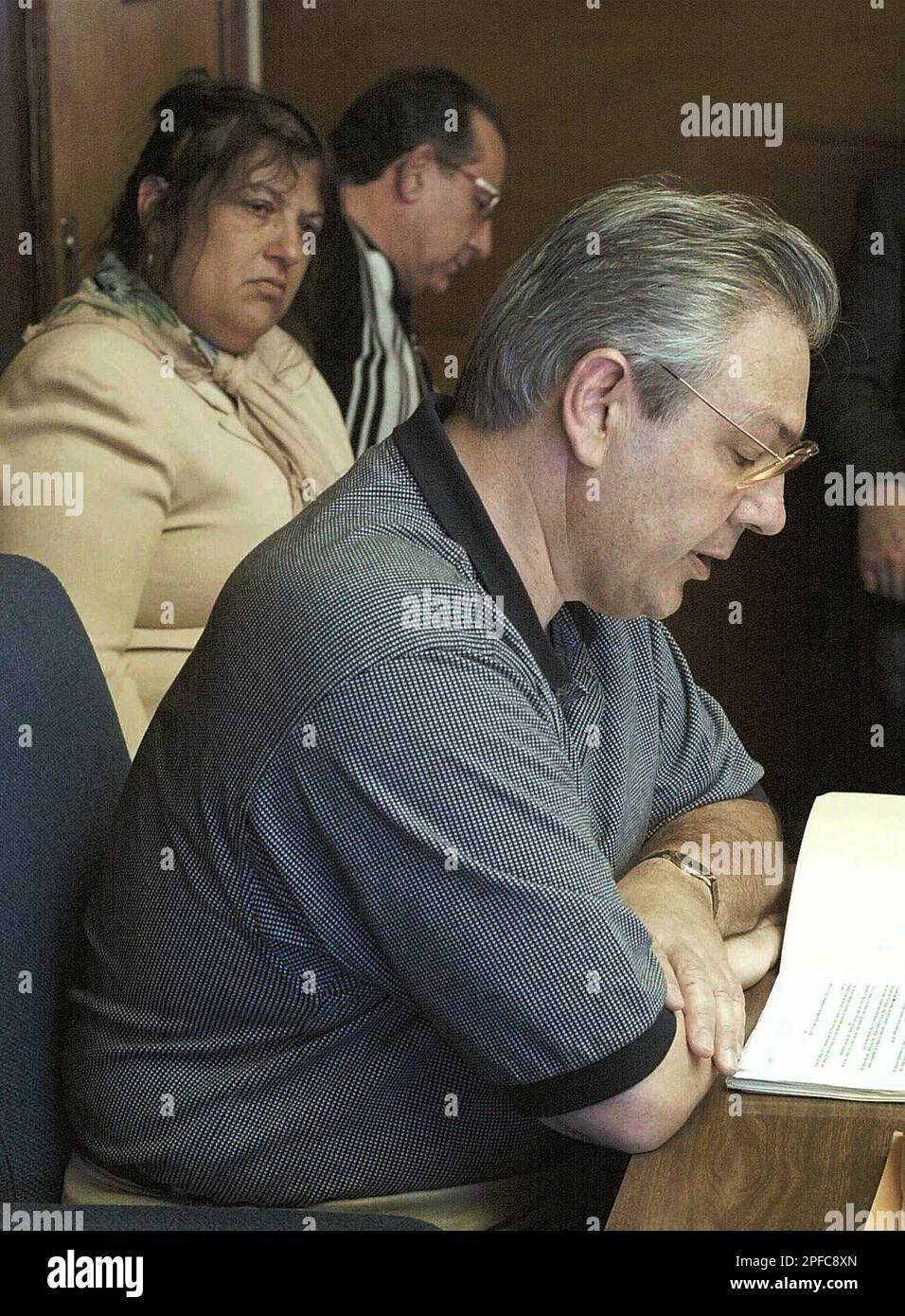 Louis Smaldino, foreground, reads a statement while his sister Angela ...