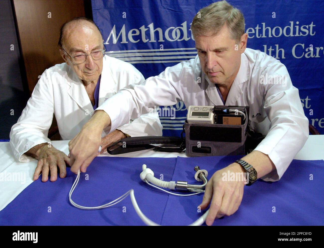 Dr. Michael DeBakey, left, watches as Dr. George Noon lays out part of ...