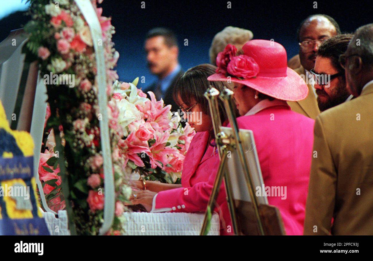 Felicia Parks Mena, center, stands at the casket of her daughter, Lori ...
